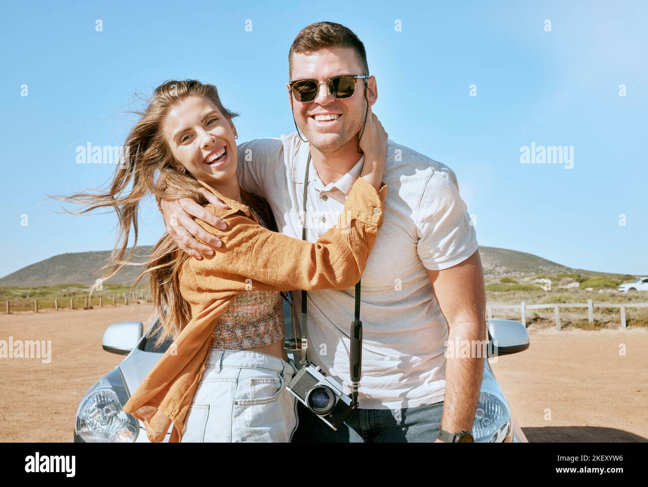Couple, hug and road trip on a summer desert holiday together with love ...