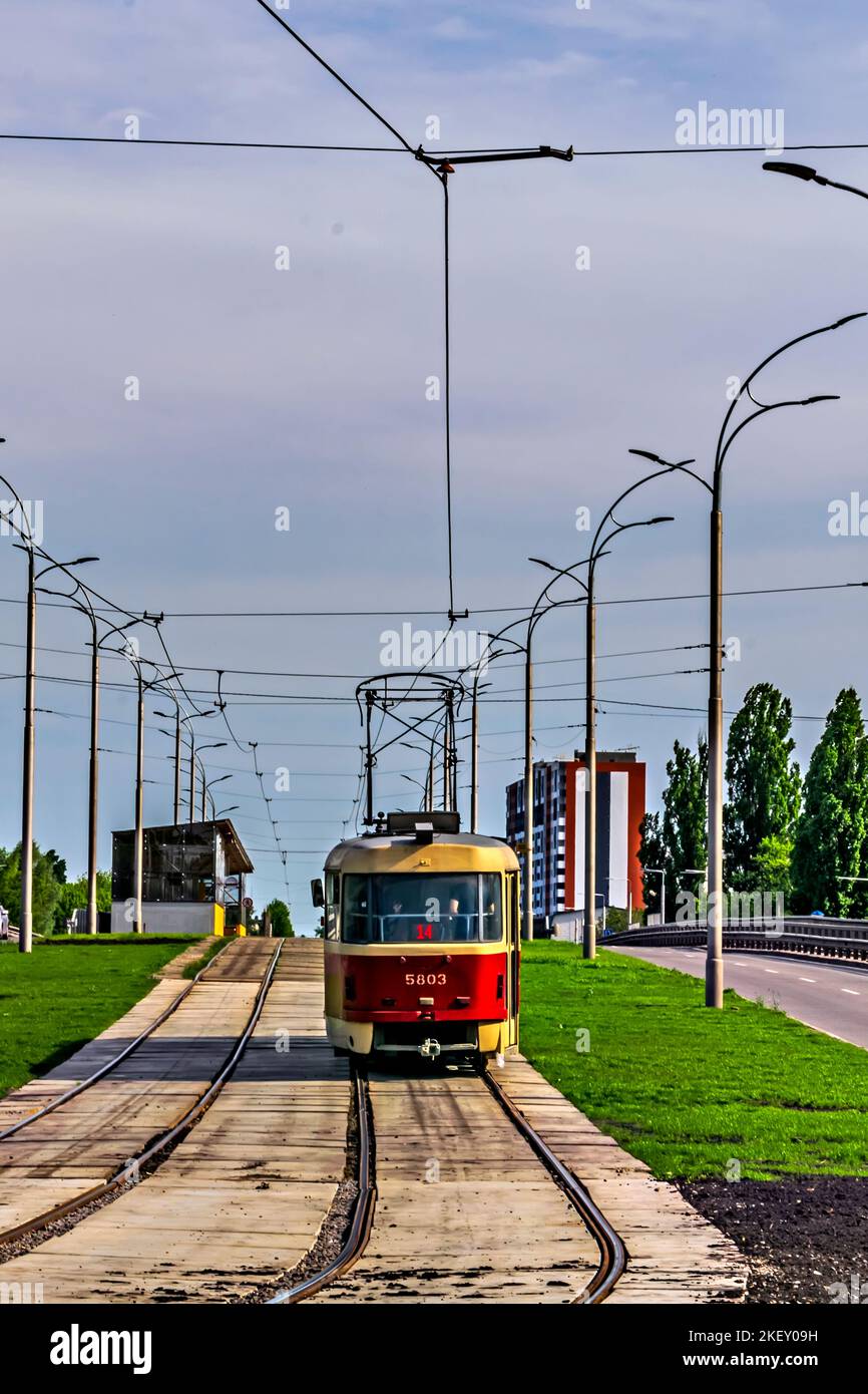 A city tram arrives the tram stop Stock Photo - Alamy