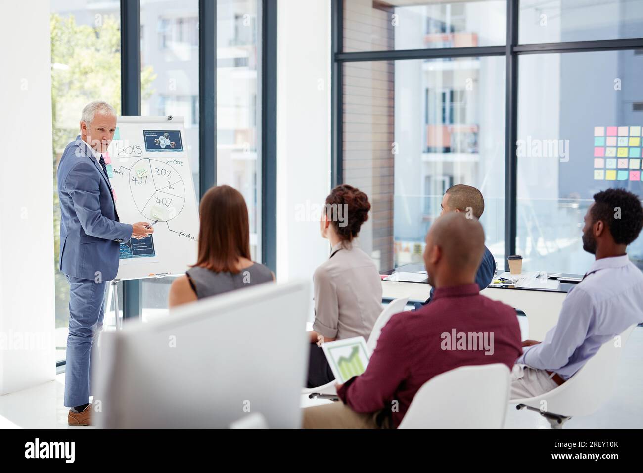 Revising their business strategies. a group of colleagues having a ...