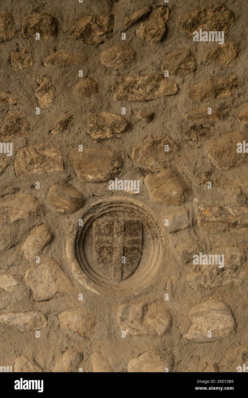 Old stone shields on the wall of the cloister. La Seu d'Urgell ...