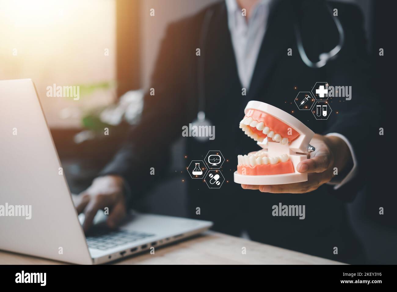 Dental care concept. Dentist with plastic teeth model and health icon ...