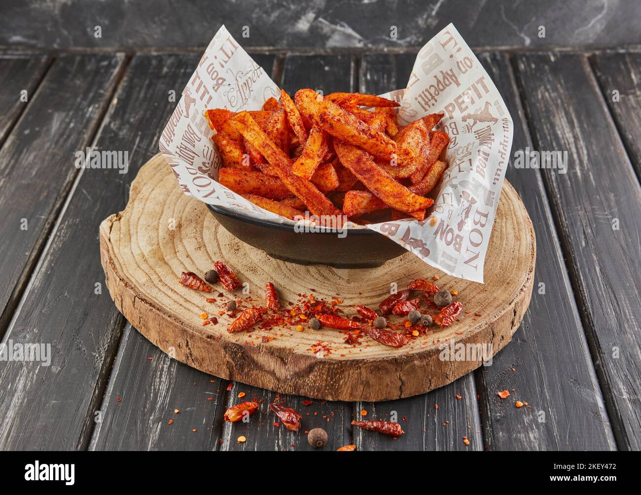 Sweet potato fried in oil with pepper on wooden board, serving in cafe ...