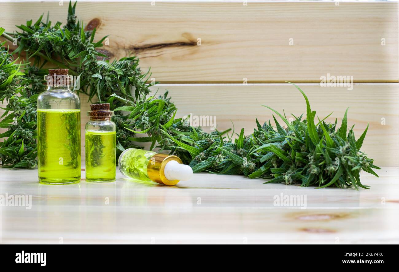 Oil cannabidiol CBD with bud marijuana on wood background Stock Photo ...