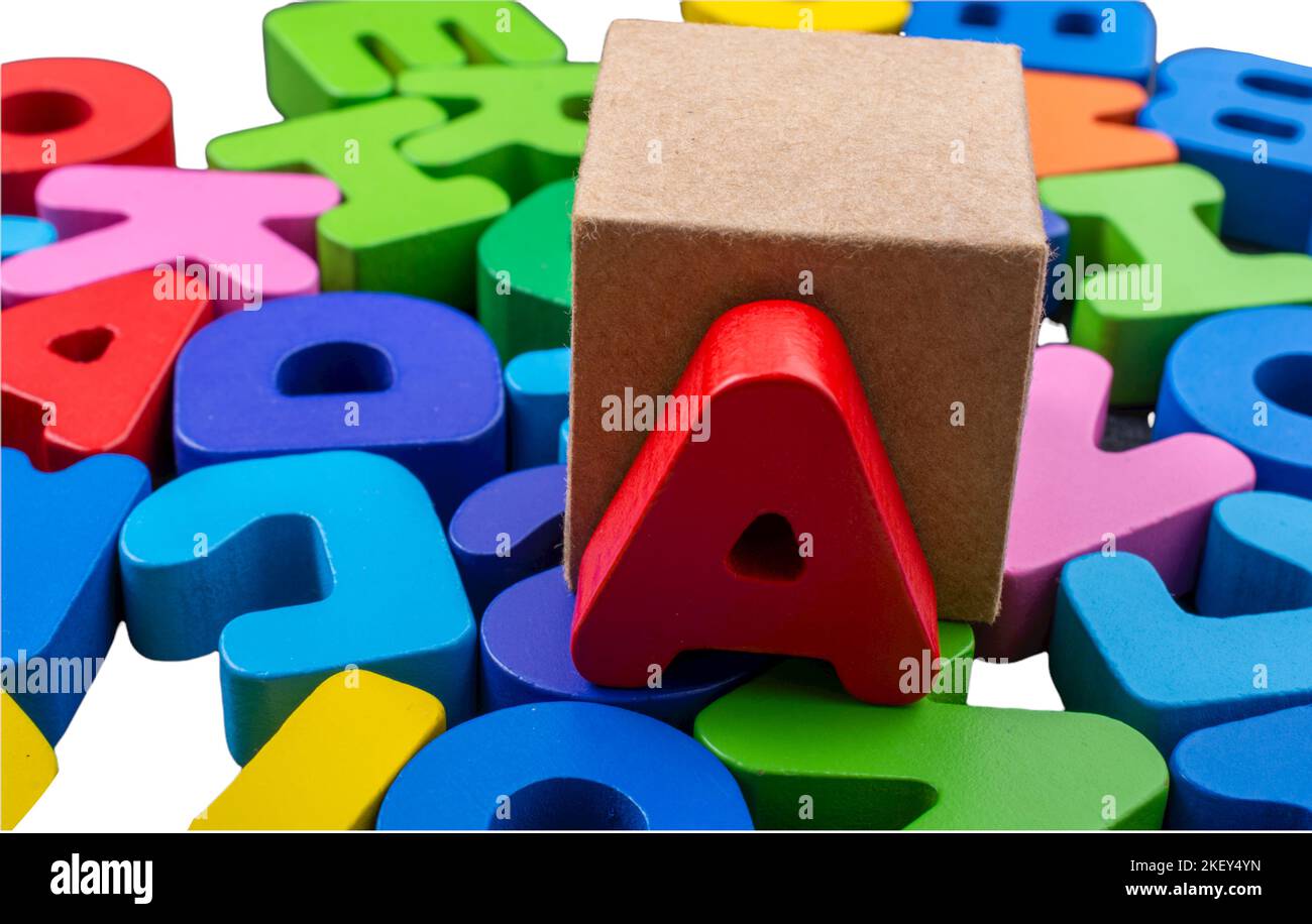 Colored wooden letters of the English alphabet on a white background ...