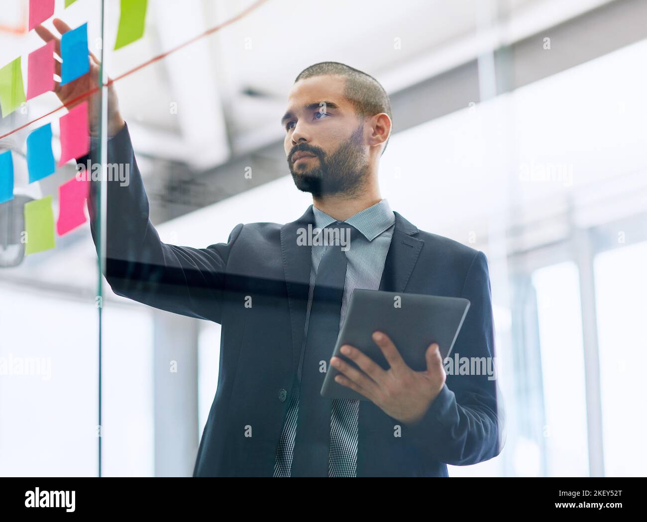 Hes a man with a plan. a serious young businessman working alone in the ...