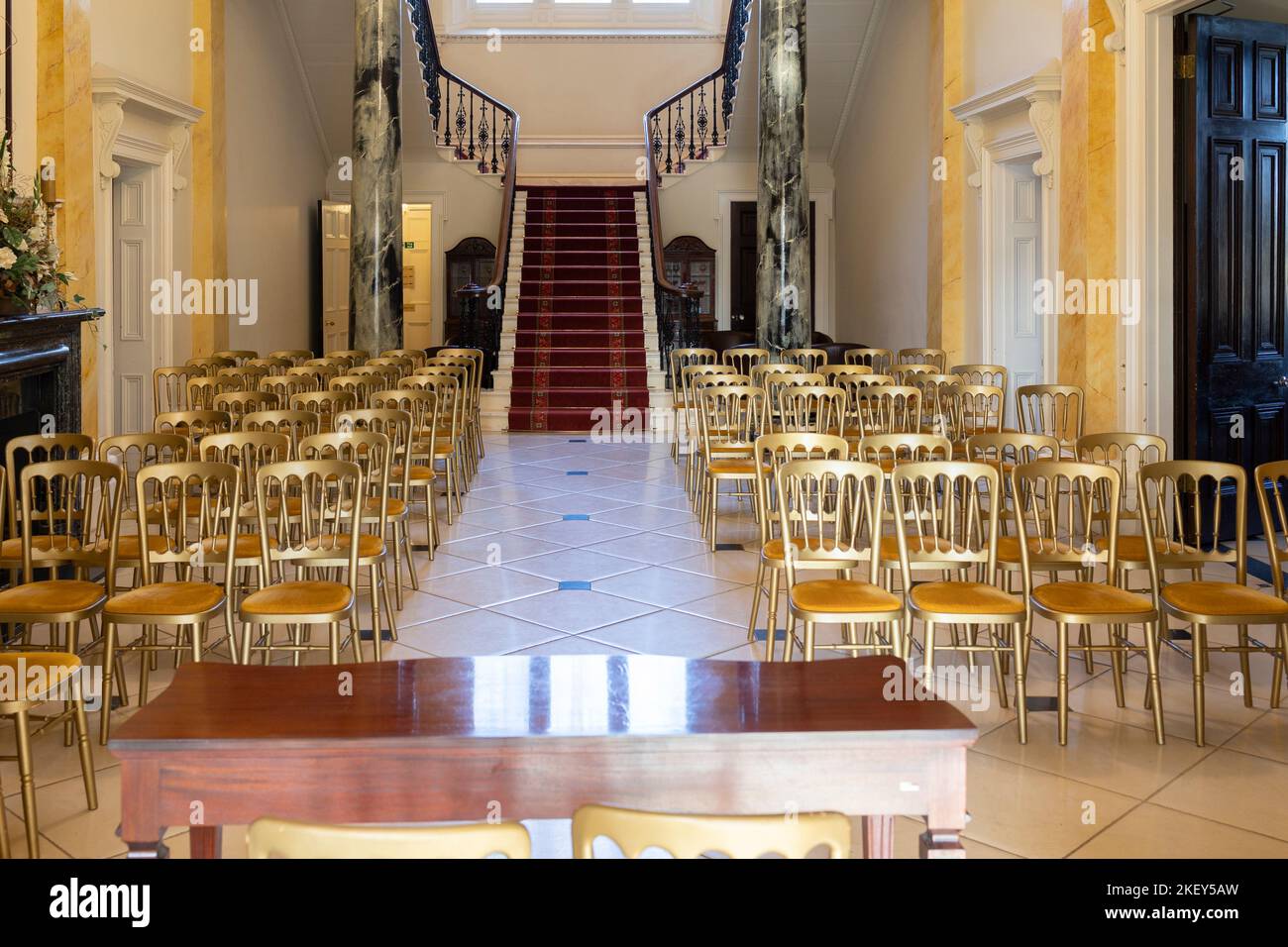 Red carpeted wooden stairwell leading into the great hall of an ...