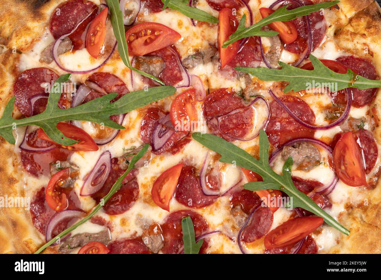 Pizza background - macro shot of pizza with pepperoni, salami and ...