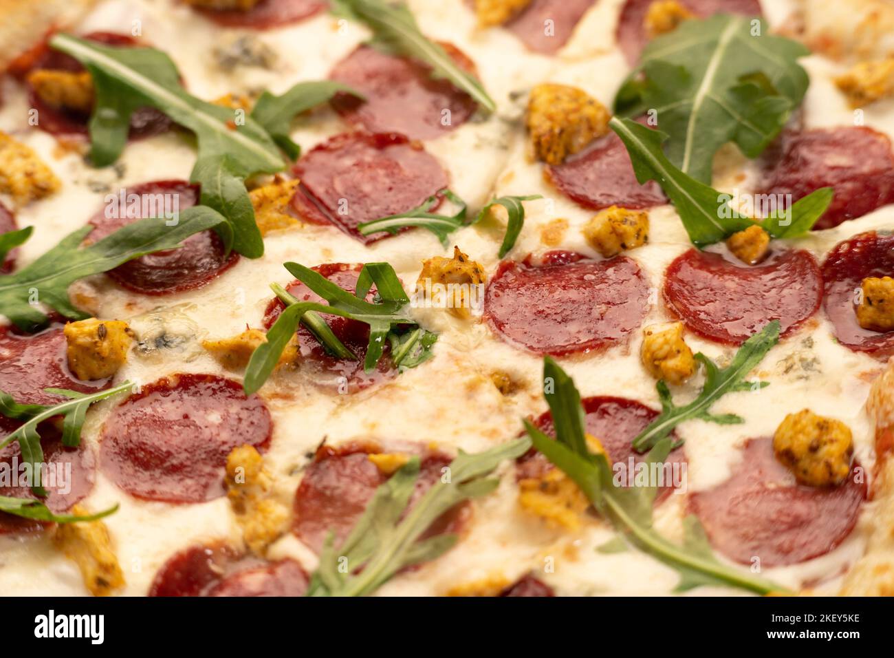Hot traditional Italian pizza with salami, meat, cheese, tomatoes ...