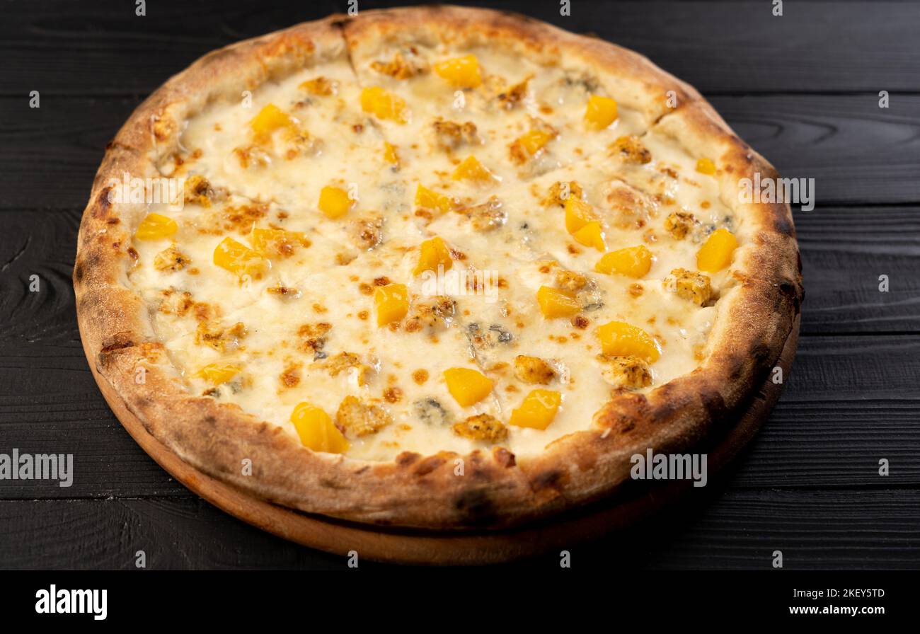 Sweet Gorgonzola pizza with honey and peach on wooden background Stock ...