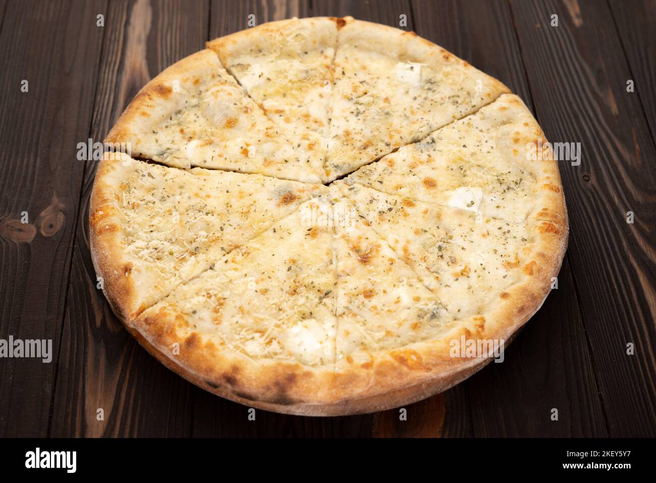 Pizza quattro formaggi slices on a wooden background. Cheese pizza Stock Photo - Alamy