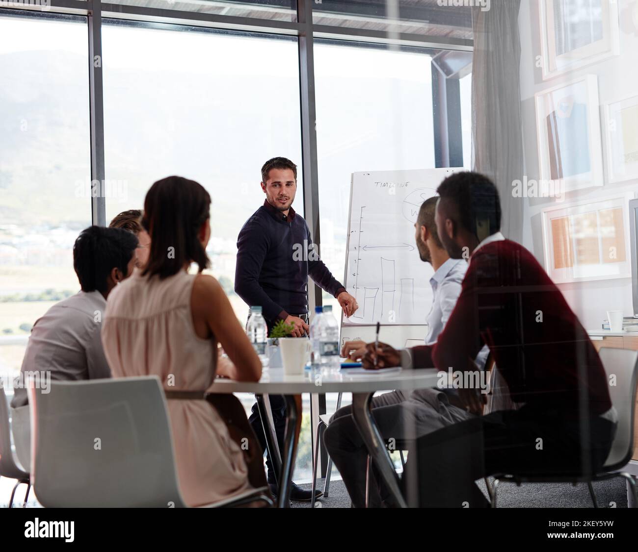 Hes got their full attention. a businessman giving a whiteboard ...