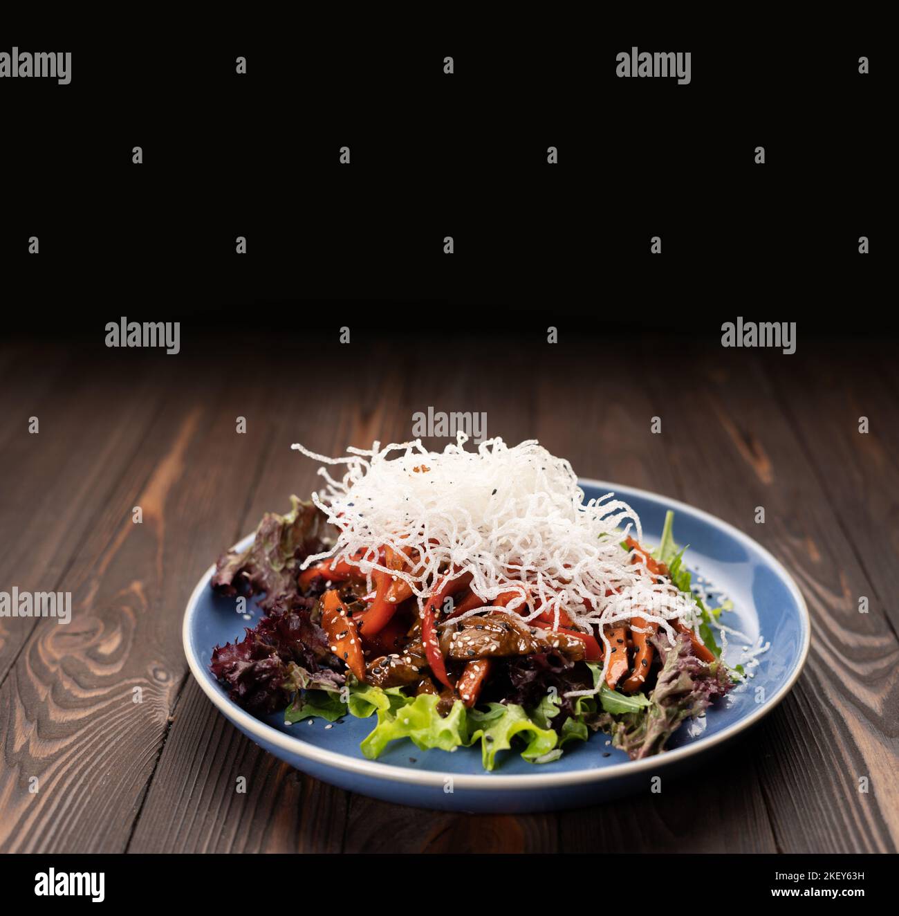 Thai fresh diet keto salad with beef meat, lettuce and sauce on dark ...