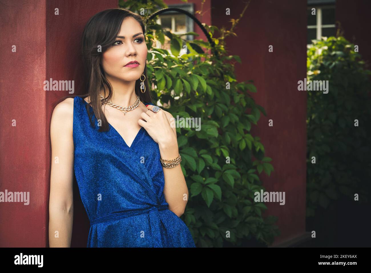 Young beautiful multiracial woman wearing in blue cocktail dress ...