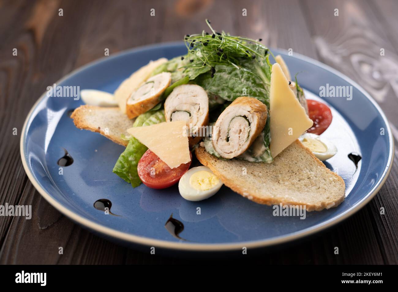 Gourmet caesar salad with grilled chicken roll on plate Stock Photo - Alamy