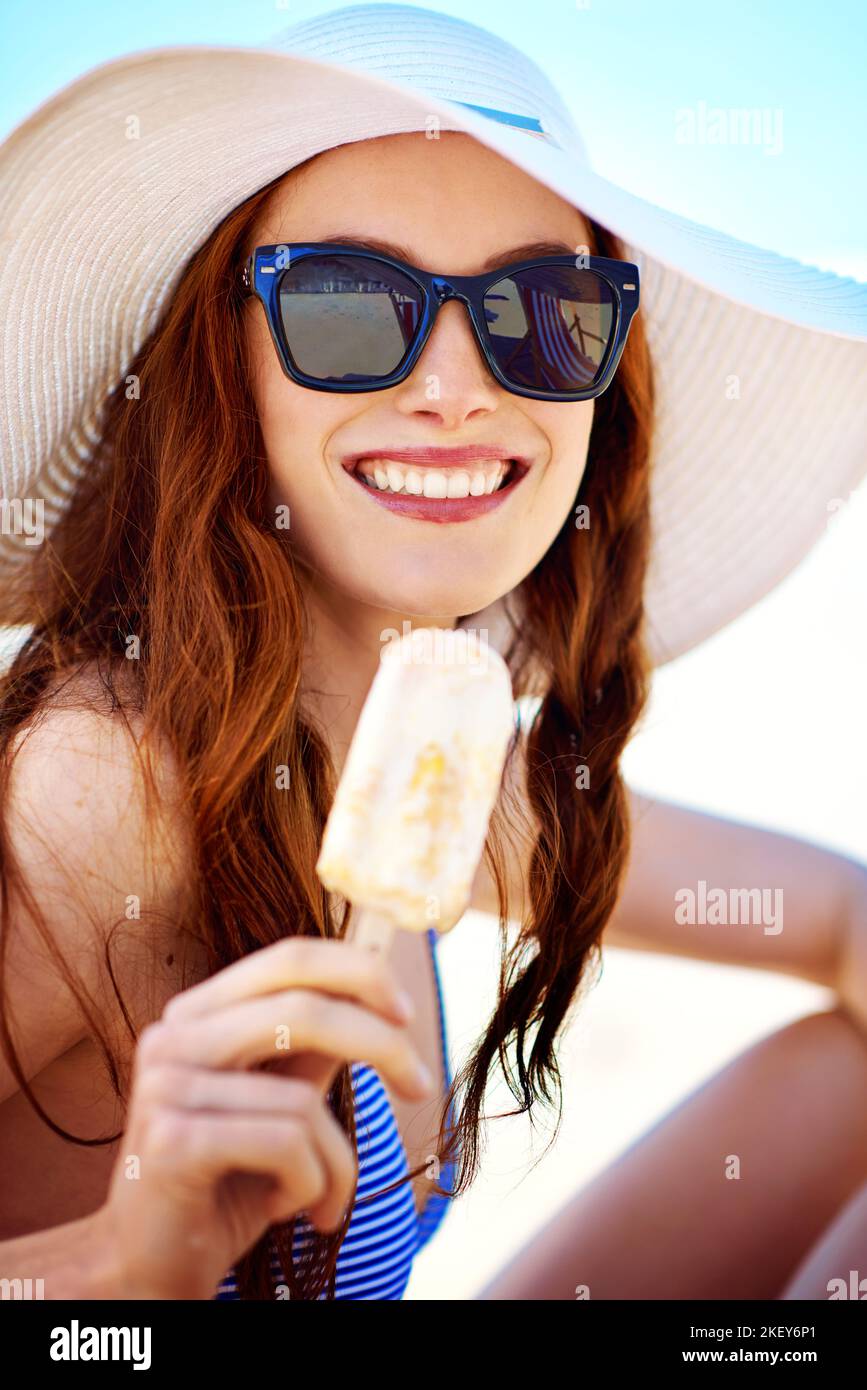 Beat The Heat With An Ice Cream Treat Portrait Of A Beautiful Young Woman Eating An Ice Cream