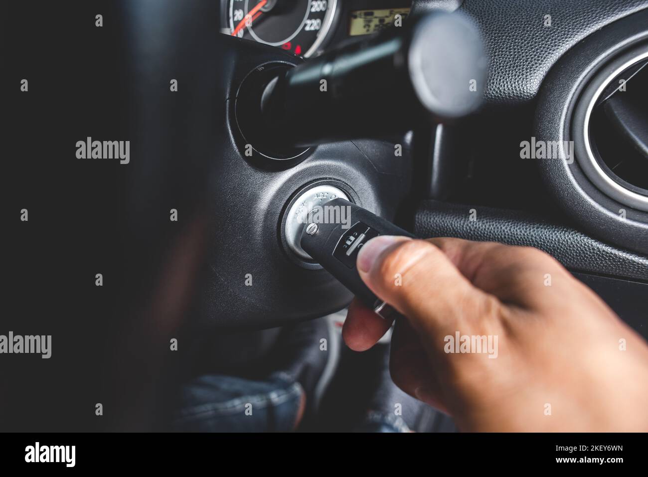 Putting the key into keyhole for ignition the engine. Start the car ...