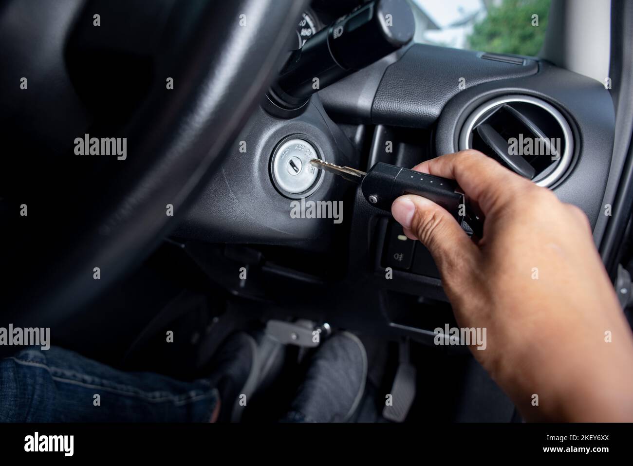Putting the key into keyhole for ignition the engine. Start the car ...