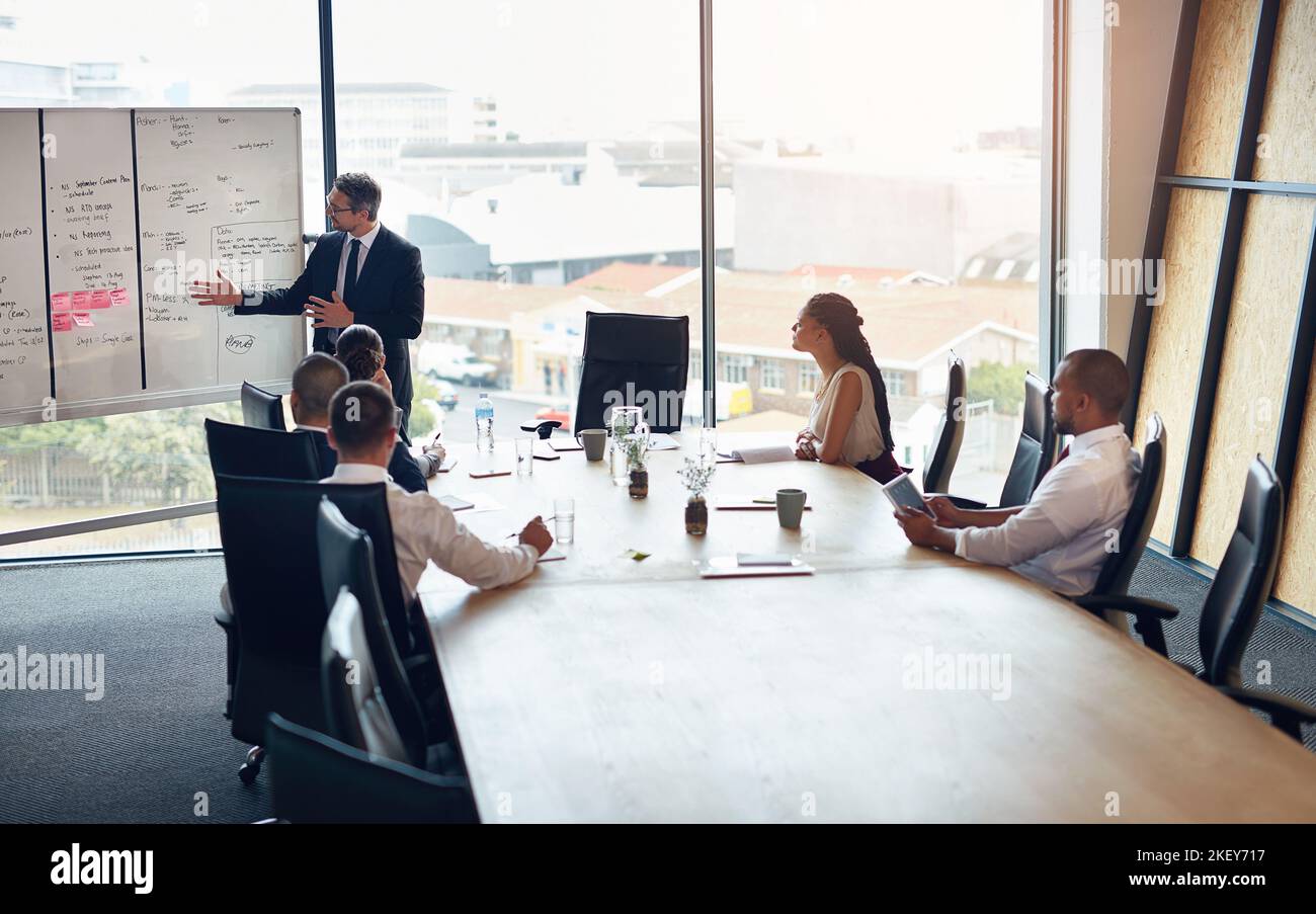 Getting the team on board with his ideas. an executive giving a ...