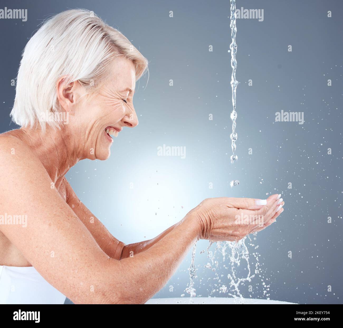 Skincare, happy and senior woman with water for face, beauty and ...