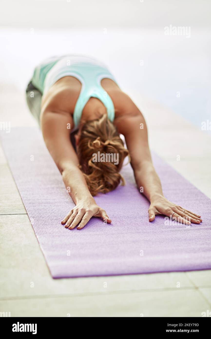 The best posture for relaxation. a young woman doing yoga Stock Photo ...