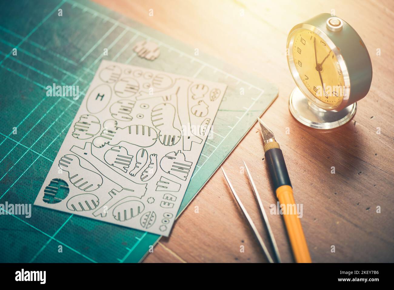 Assembling small cardboard model, the small cardboard parts are made ...