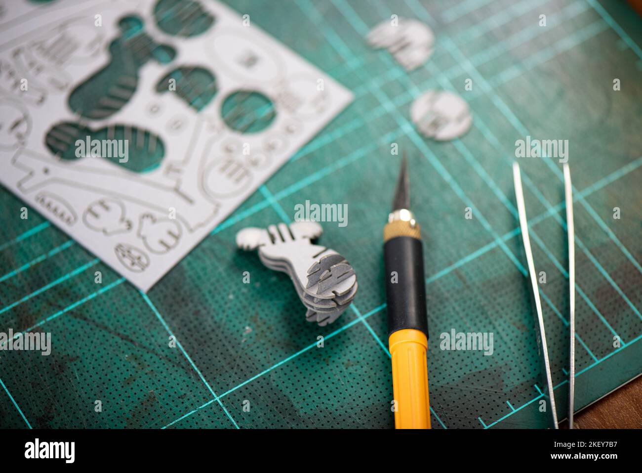 Assembling small cardboard model, the small cardboard parts are made ...