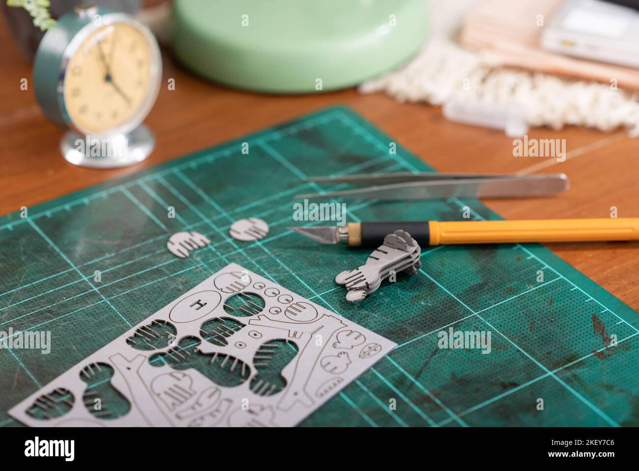 Assembling small cardboard model, the small cardboard parts are made ...