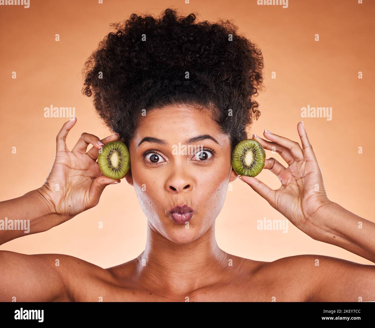 Face, beauty and kiwi with a model black woman in studio on a beige ...