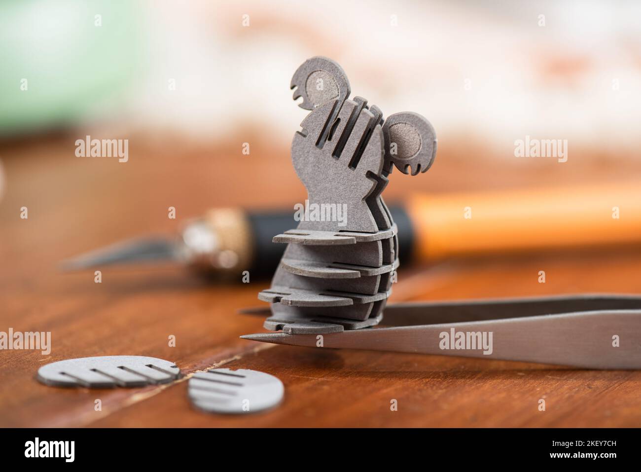 Assembling small cardboard model, the small cardboard parts are made ...