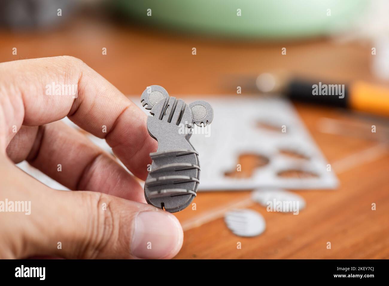 Assembling small cardboard model, the small cardboard parts are made ...