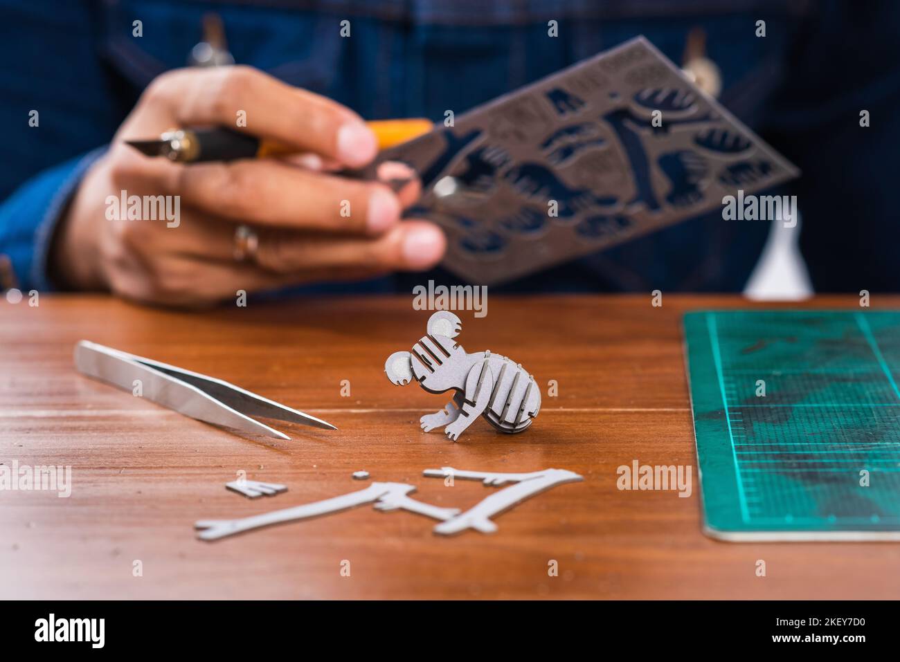 Assembling small cardboard model, the small cardboard parts are made ...