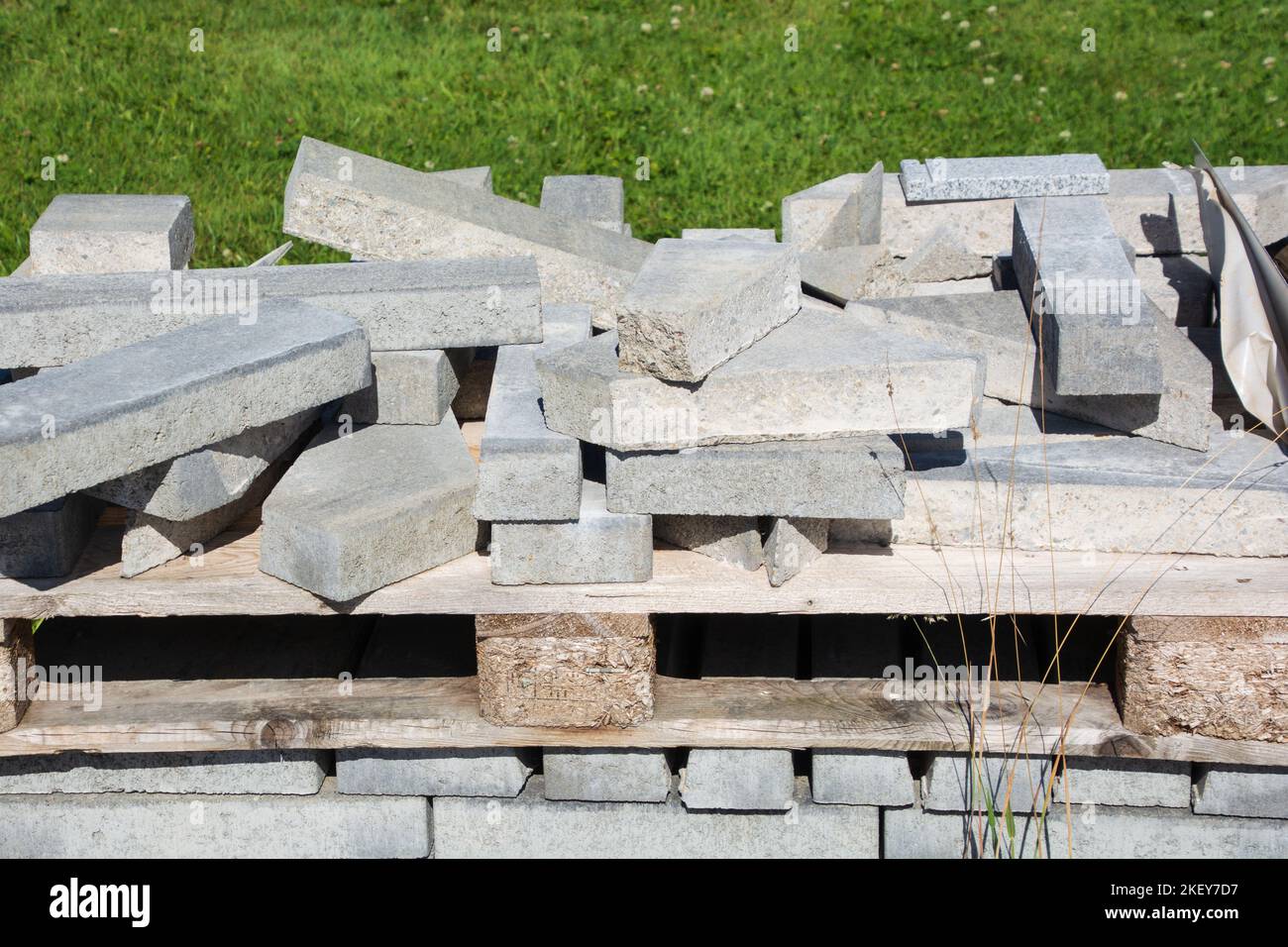 Stacked Concrete plates At Construction Site in front of green grass ...