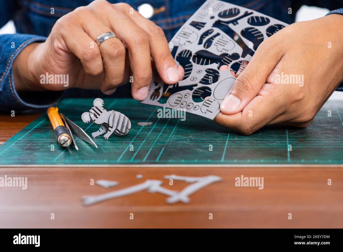 Assembling small cardboard model, the small cardboard parts are made ...