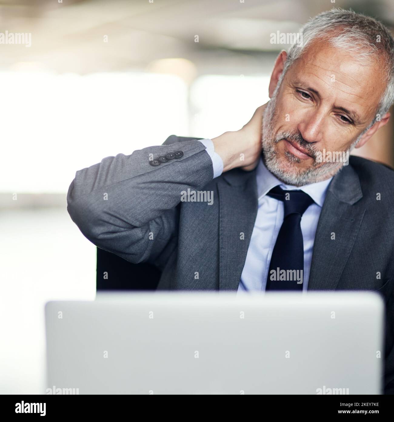 He needs some stress management. a mature businessman looking stressed ...