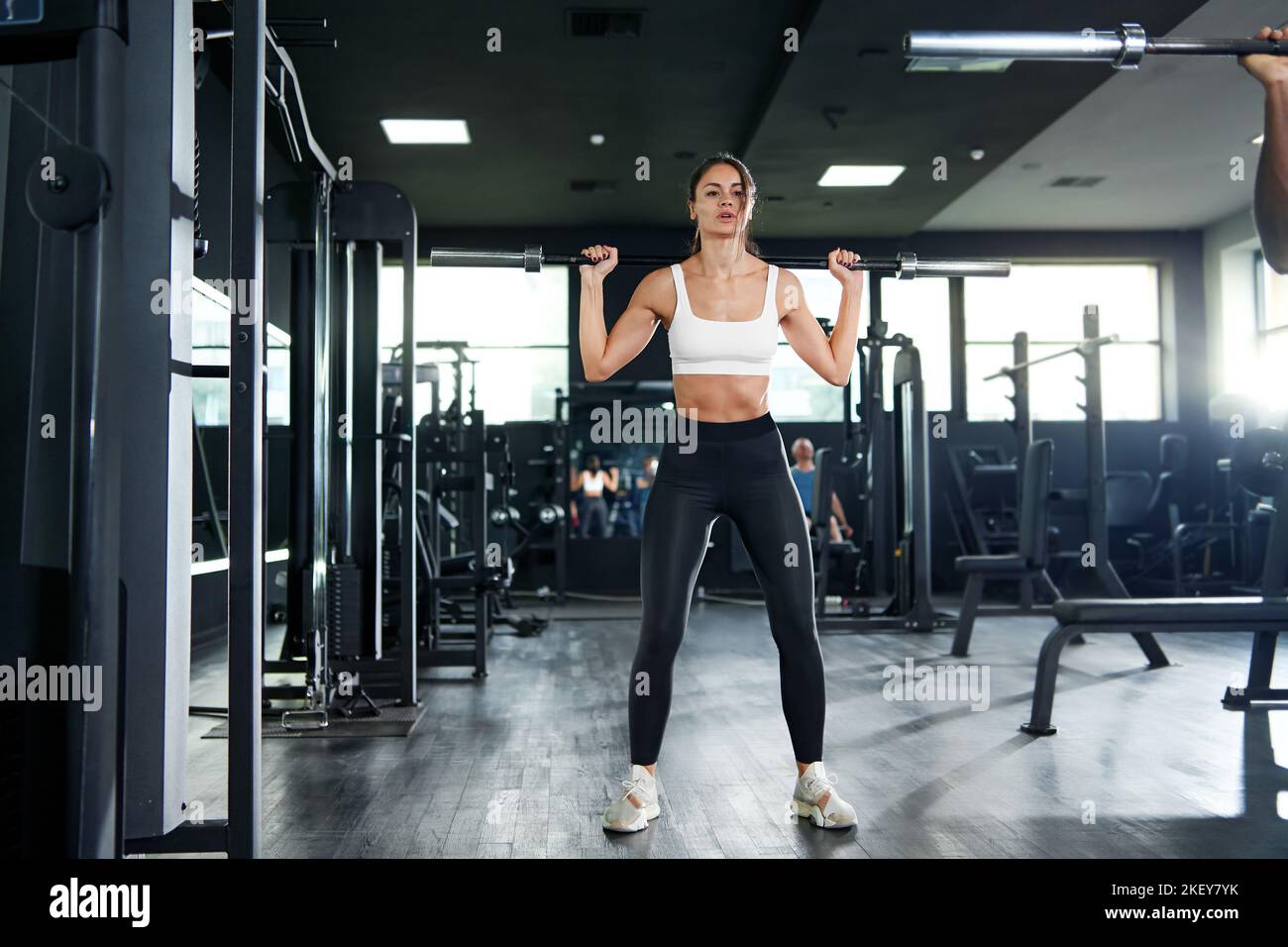 sporty young woman performing a barbell press Stock Photo - Alamy