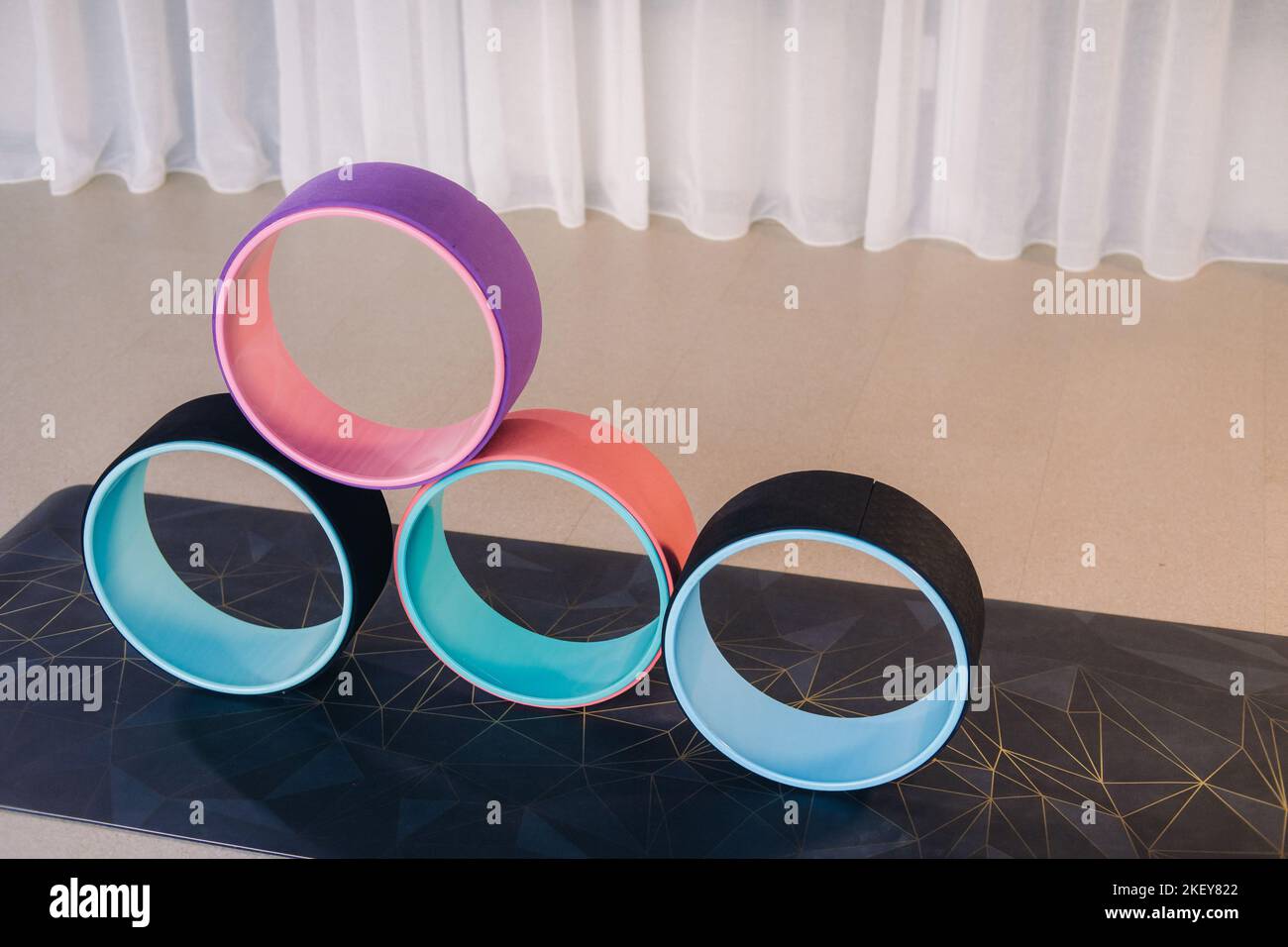 a set of yoga wheels lying on the mat. Fitness Equipment Pilates Ring ...