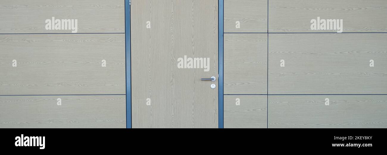 Wooden door to match wall in building background Stock Photo - Alamy