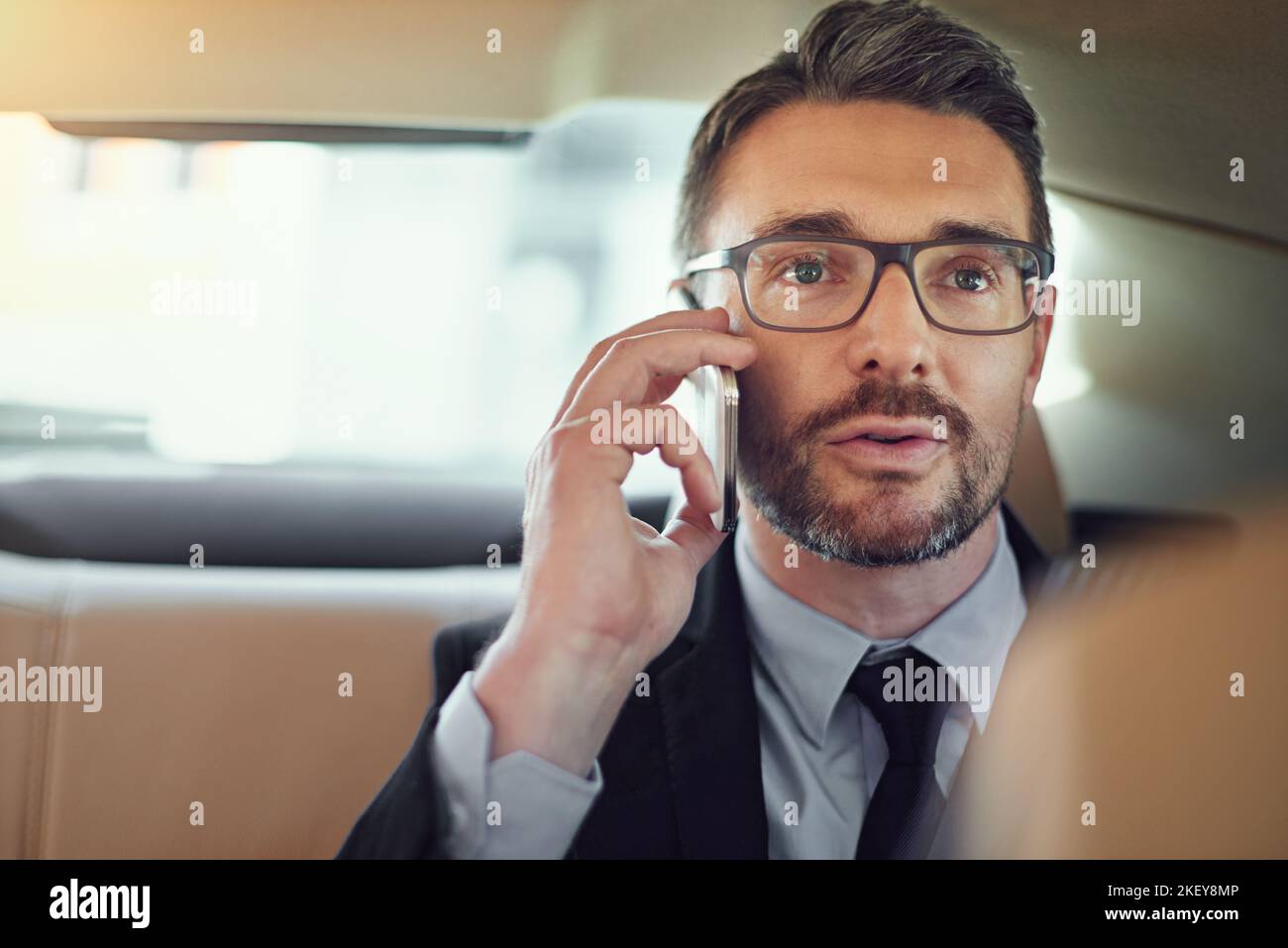 I can ask the driver to pick you up on the way. a businessman using his ...