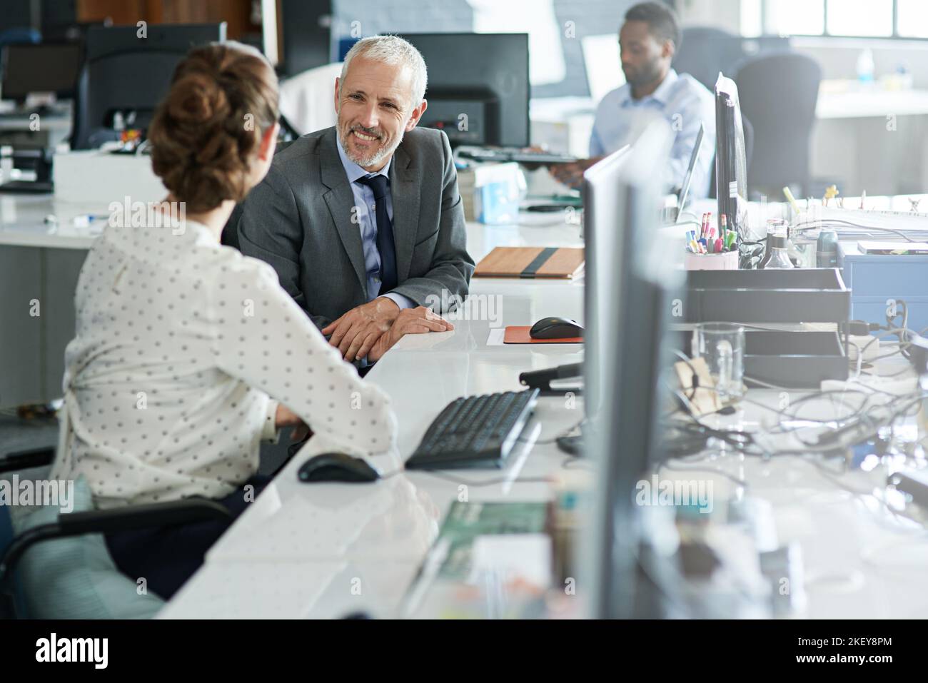 Making time to talk with his staff. two colleagues talking together ...