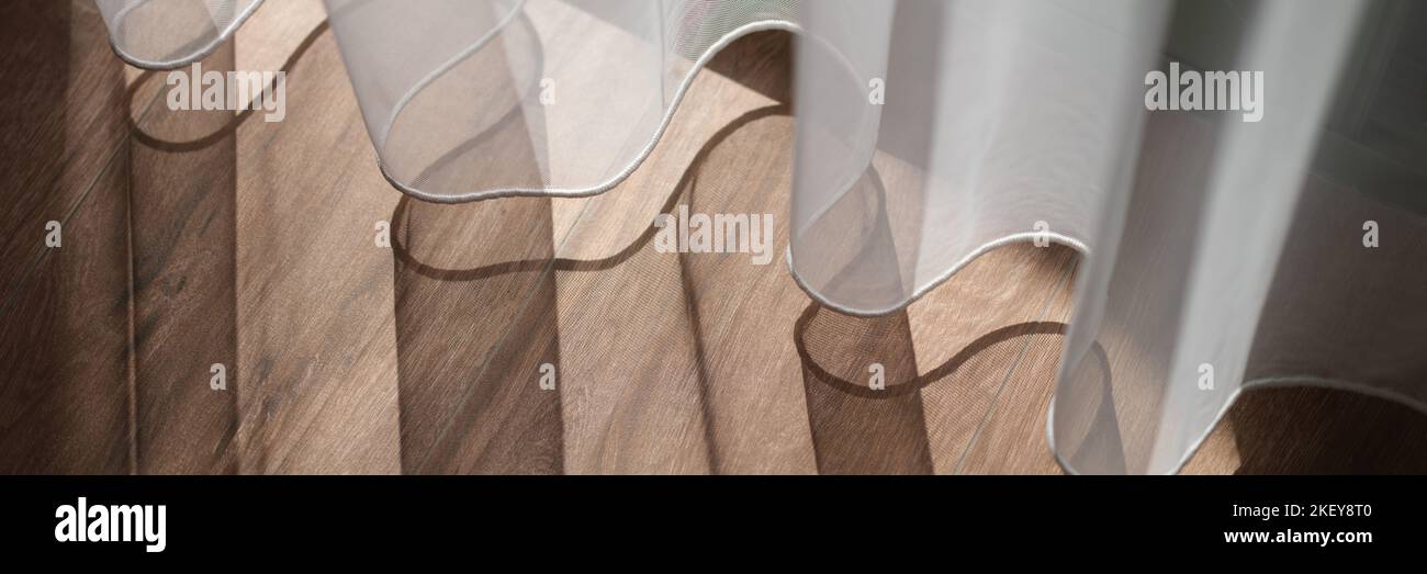 Sunlight falling on wooden floor and creating shadow from curtains ...