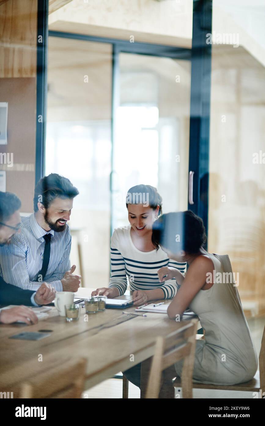 Theyve got technology on their side. Through glass shot of a group of ...