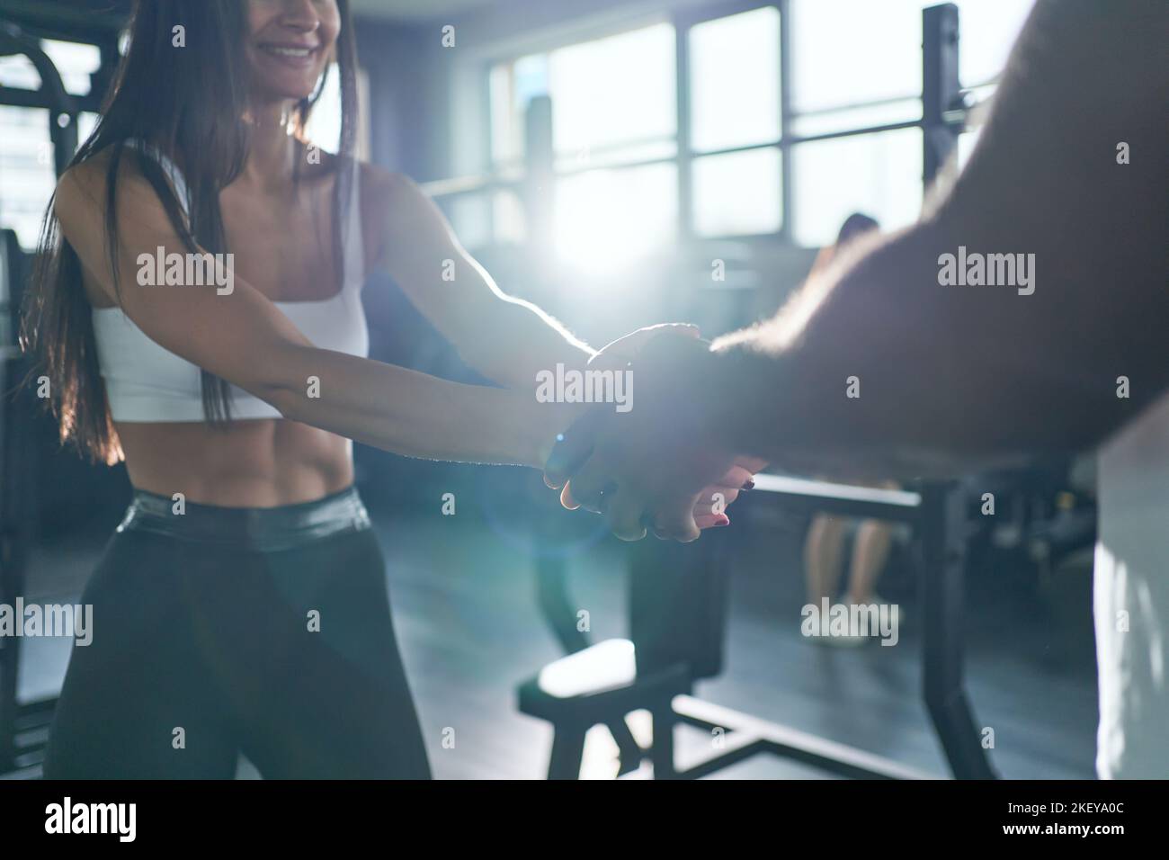 trainer and fitness woman shaking hands with each other Stock Photo - Alamy