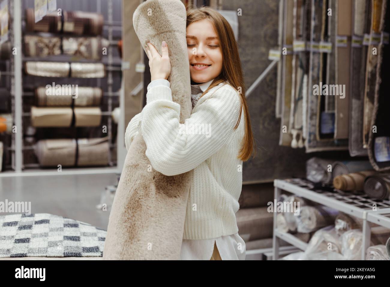 Woman touching and hugging soft fluffy carpet in hardware store, home ...