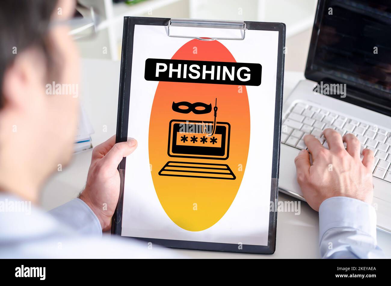 Man holding a clipboard with phishing concept Stock Photo - Alamy
