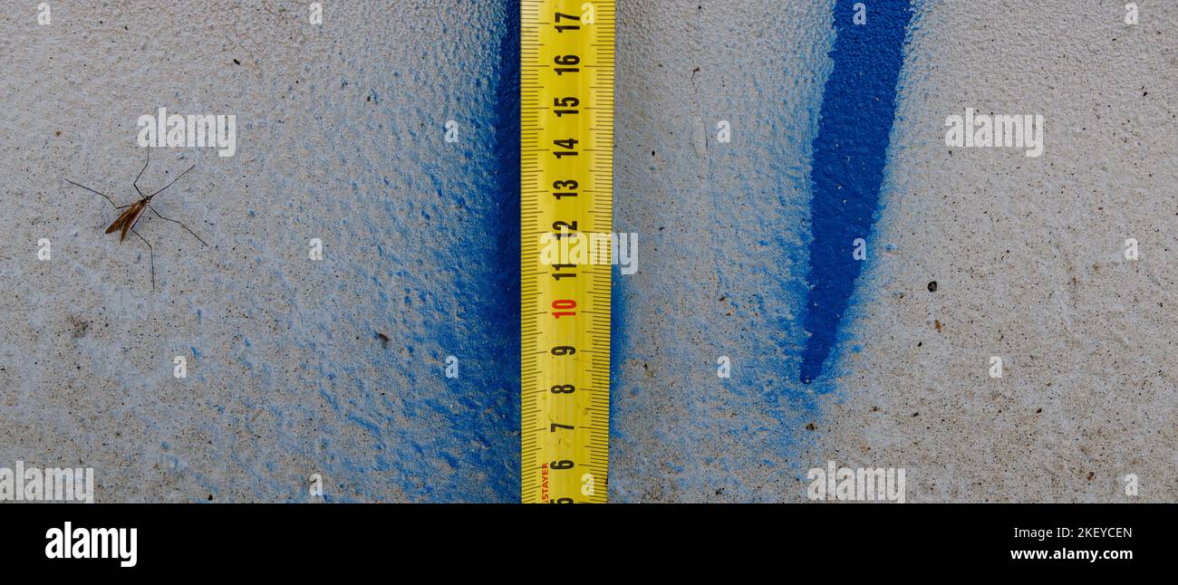 Measuring ruler on a concrete wall texture. The concept of renovation ...