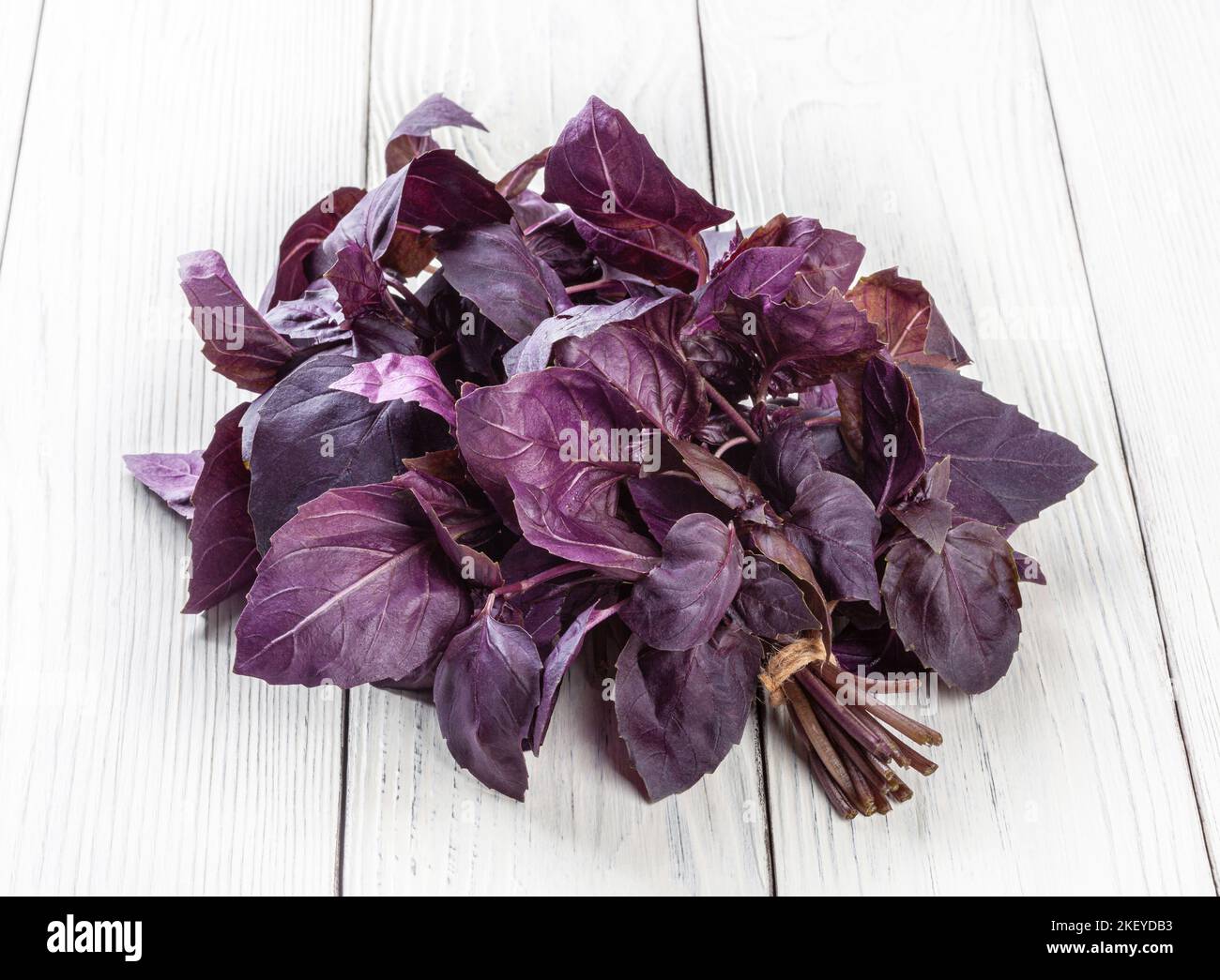 Fresh purple basil leaves on white wooden background Stock Photo - Alamy