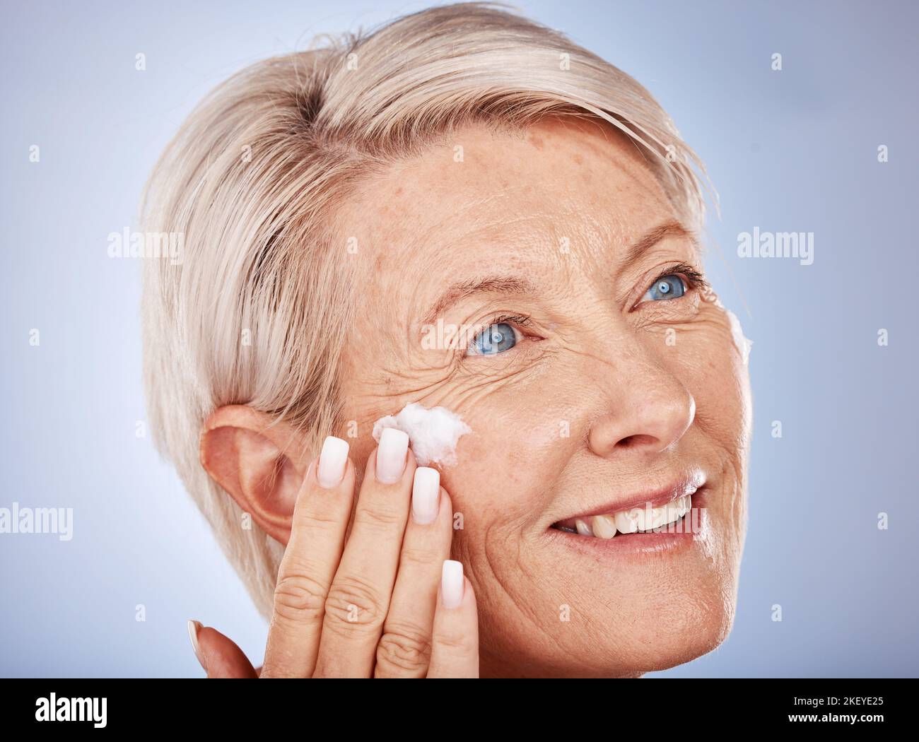 Skincare, thinking and senior woman with cream for face against a grey ...