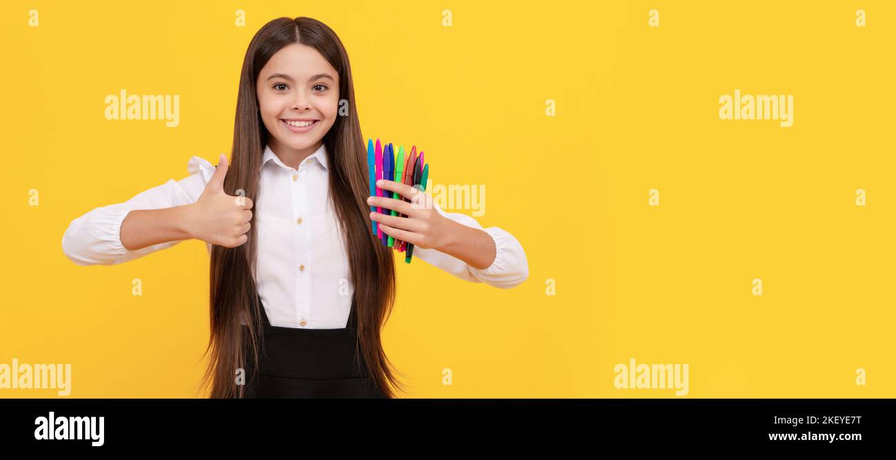 Happy girl child hold felt-tip pens showing thumbs up hand gesture ...
