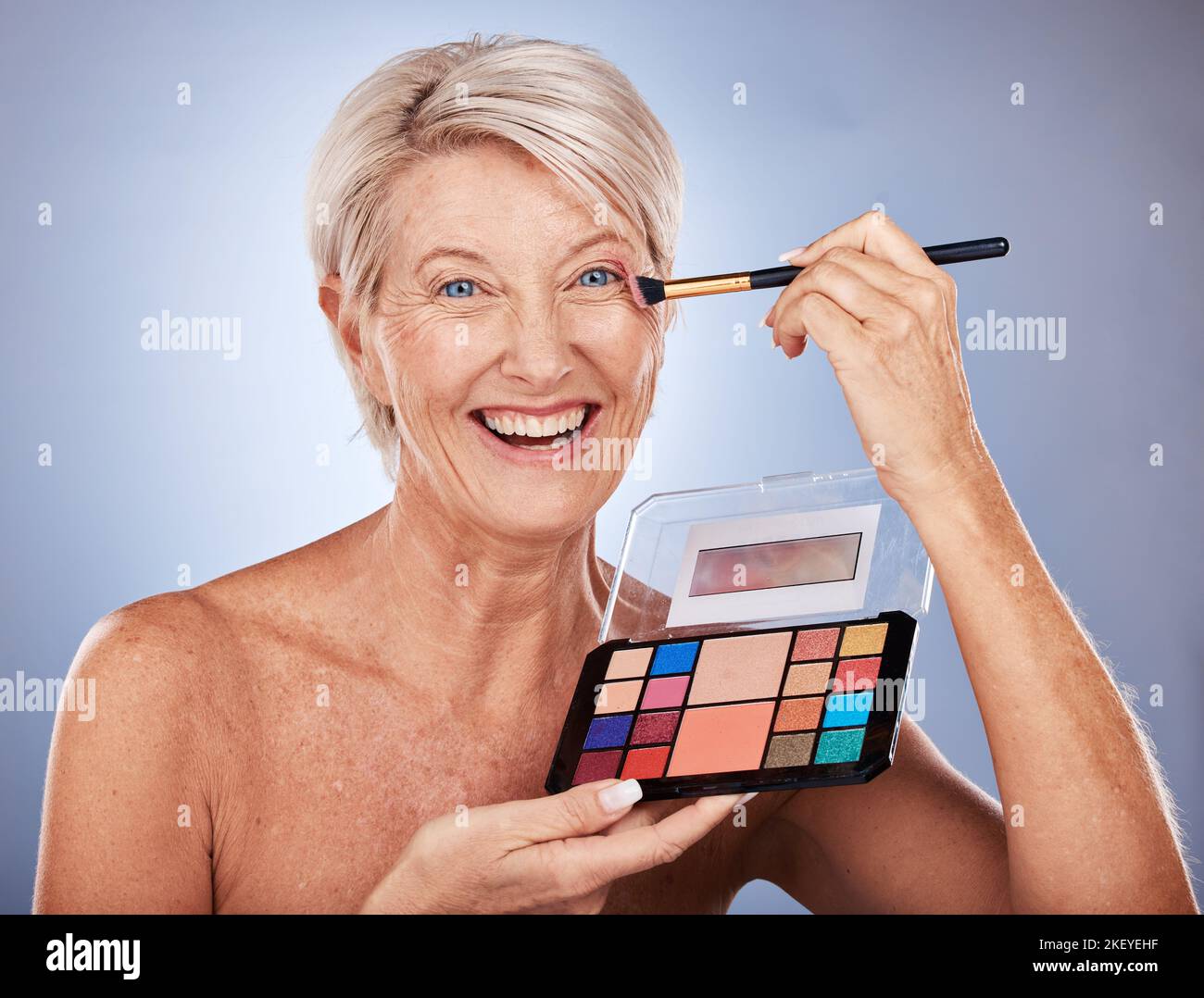 Makeup, portrait and senior woman with brush to apply luxury product ...