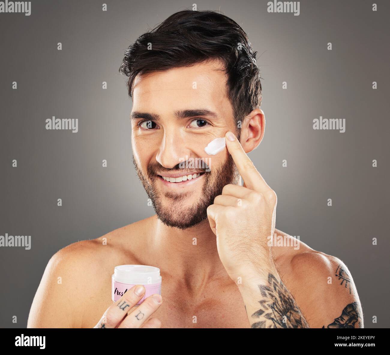 Skincare, wellness and man with facial cream isolated on gray ...